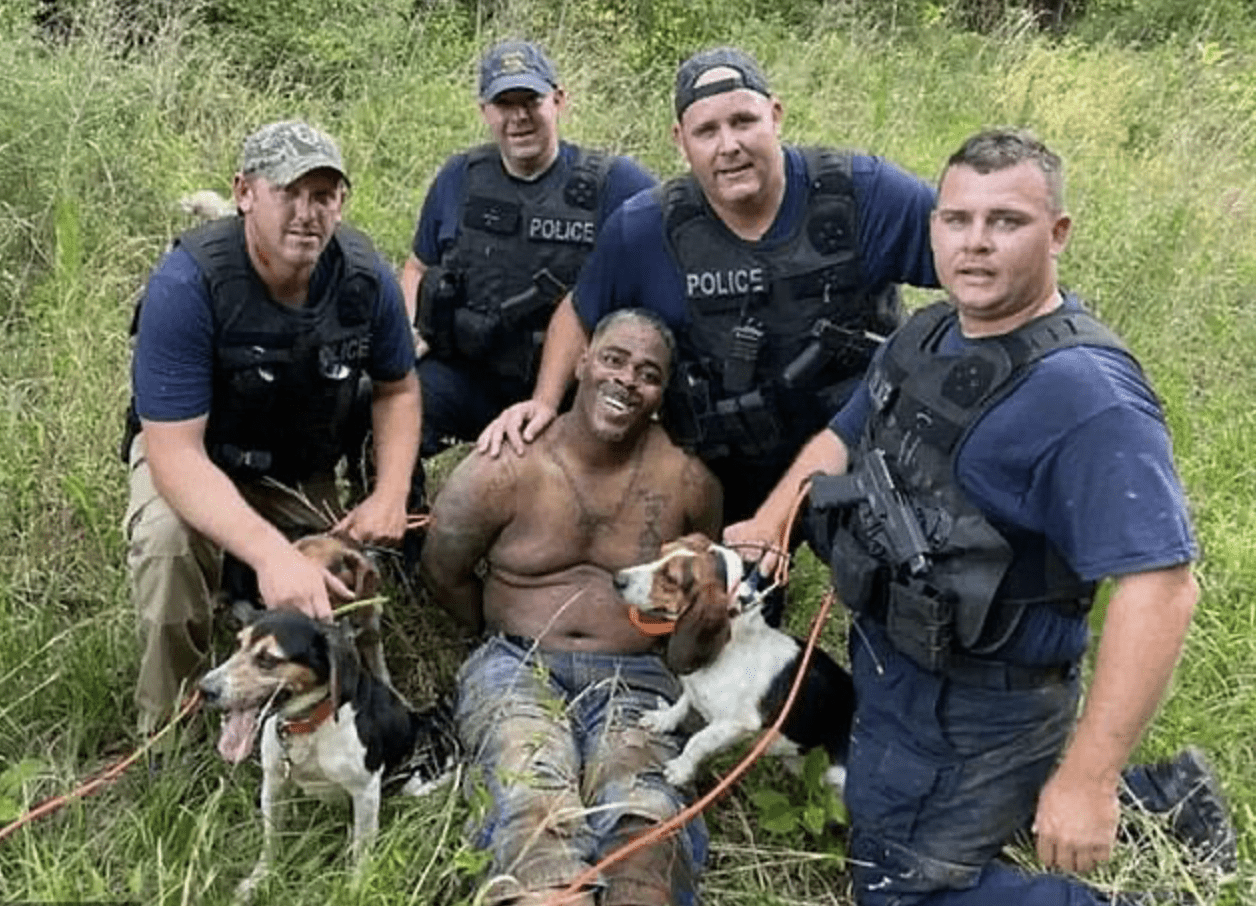 Cops spark outrage after posing with bank robbery suspect after large ...